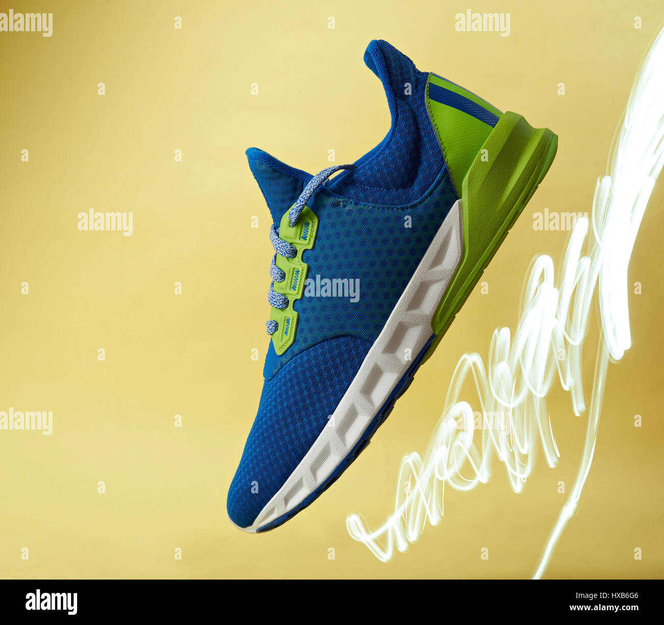 Colorful fast running shoe isolated on yellow background with light ...