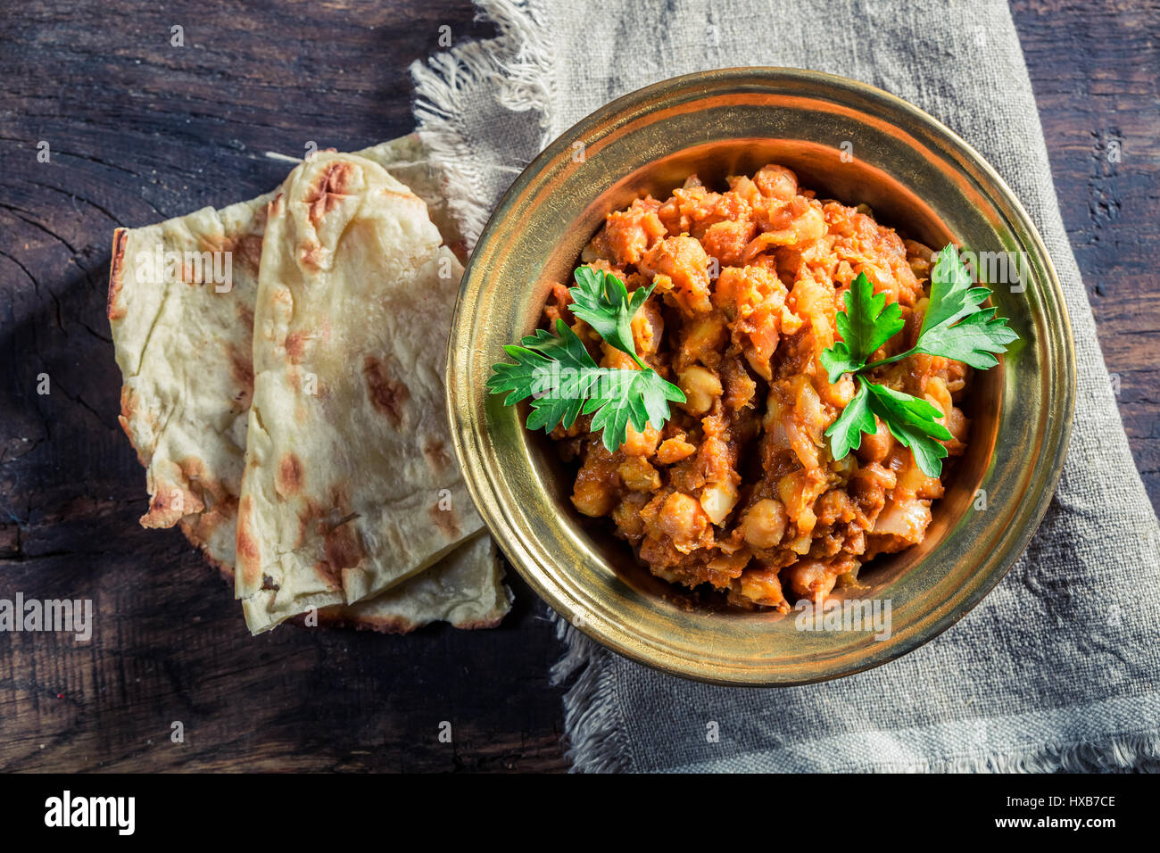 Indian Channa Masala with chickpeas on old wooden table Stock Photo - Alamy