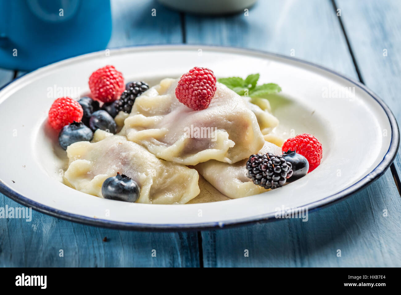 Delicious dumplings with fresh fruits and cream Stock Photo - Alamy