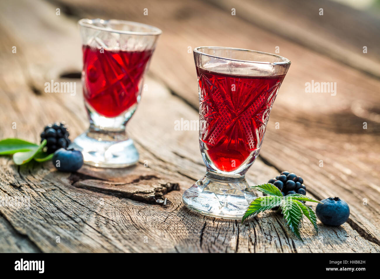 Sweet liqueur with alcohol and berry fruits Stock Photo - Alamy