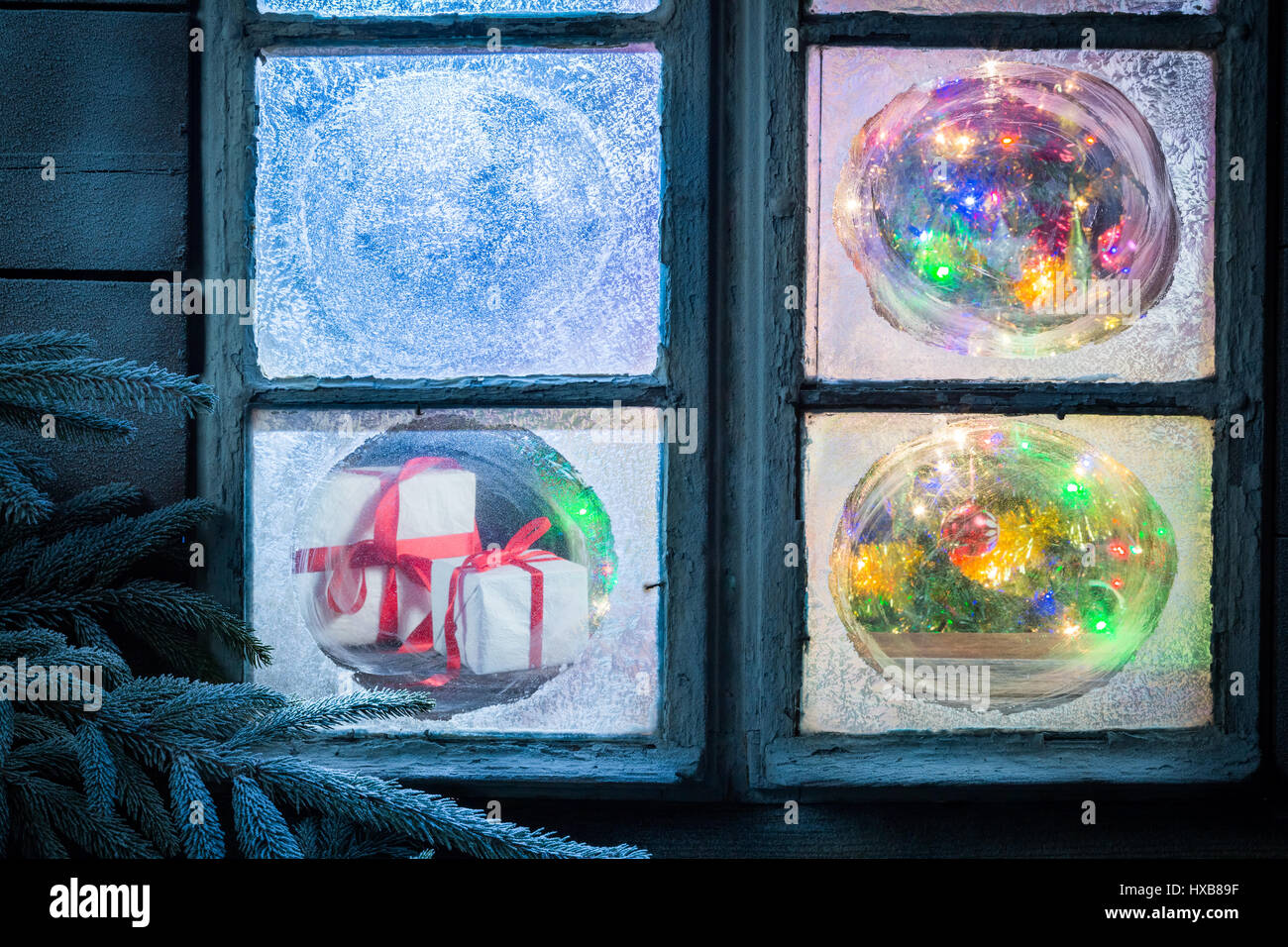 Adorable gifts for Christmas in frozen window Stock Photo - Alamy