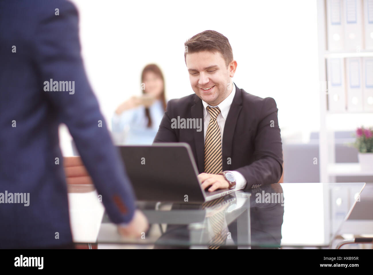 Happy smart business man with team mates discussing in background Stock ...
