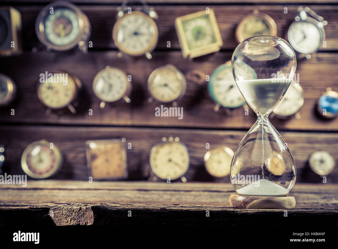Old hourglass on the background of clocks Stock Photo - Alamy