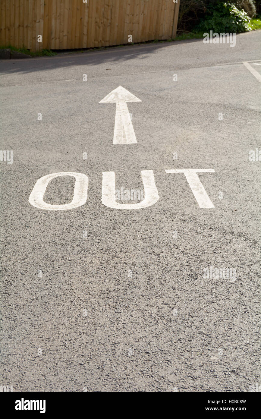 Out sign with direction arrow painted on tarmac in car park Stock Photo ...