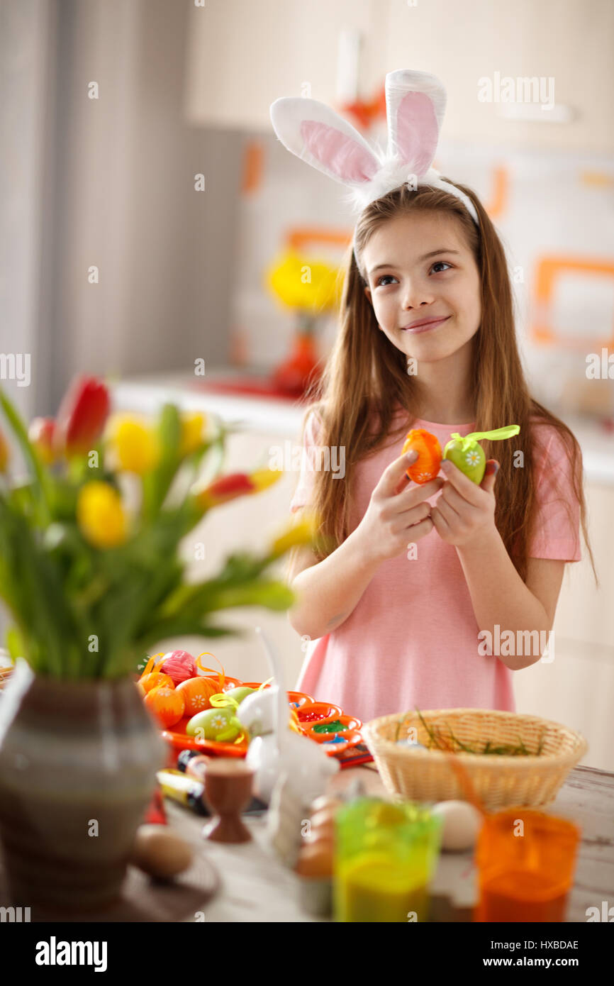 Girl with just painted Easter eggs can’t decide which is better Stock ...
