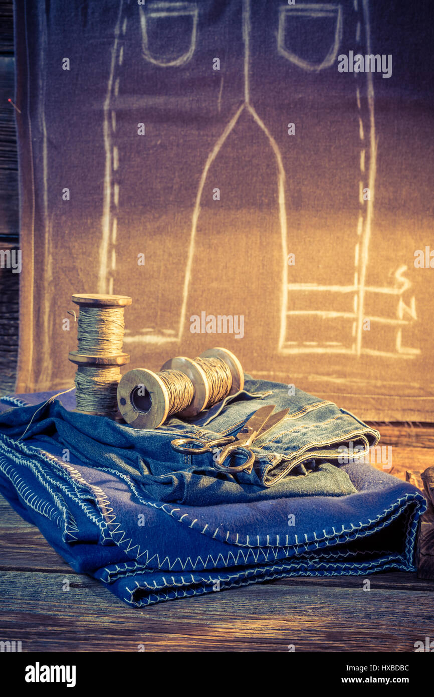 Cloth, needle and scissors in tailor workshop Stock Photo - Alamy