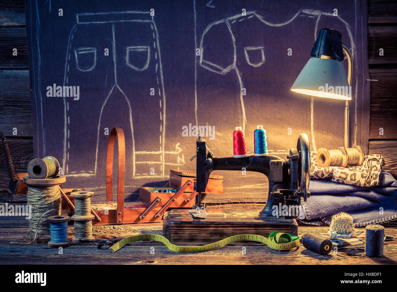 Old tailor workshop with sewing machine and cloth Stock Photo - Alamy