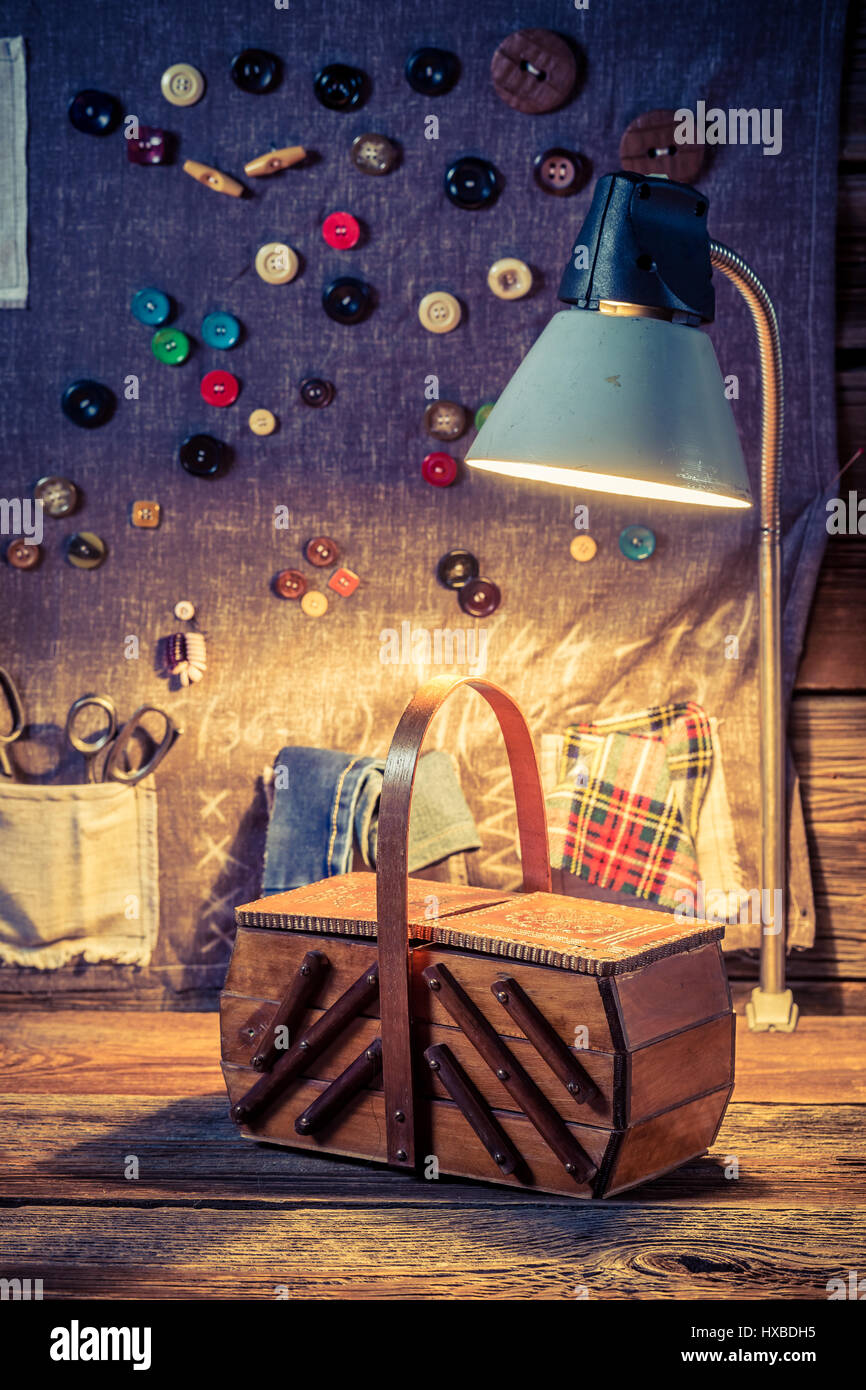 Sewing cloth with scissors, needles and threads in tailor workshop ...