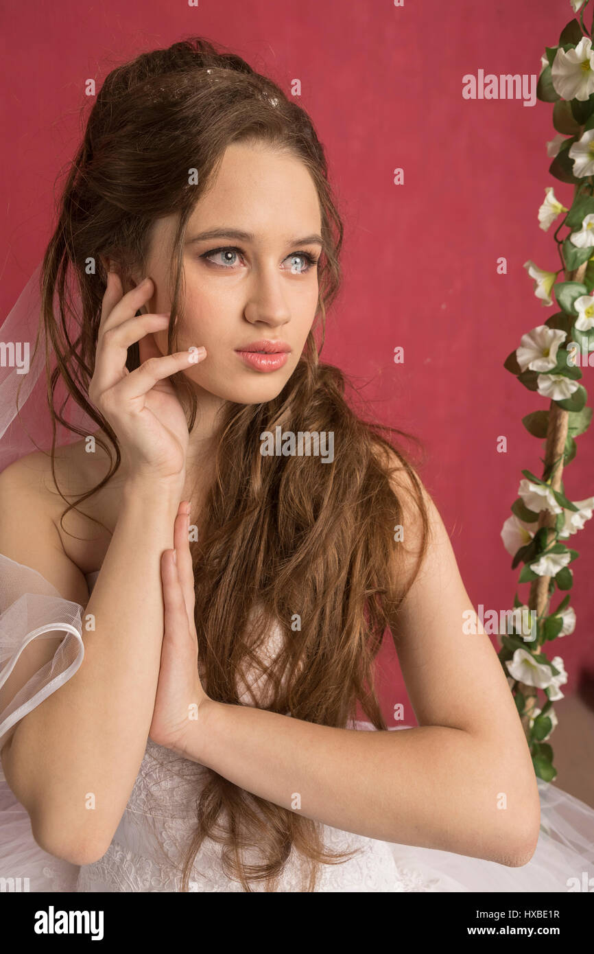 Charming bride sitting on a swing Stock Photo - Alamy