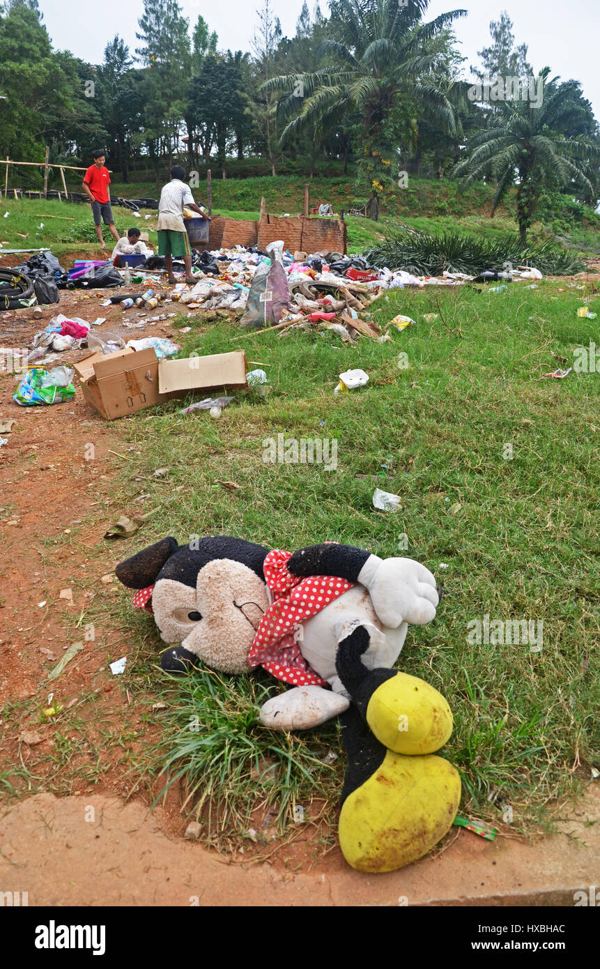 A discarded Minnie Mouse soft toy on the ground near a rubbish tip in ...