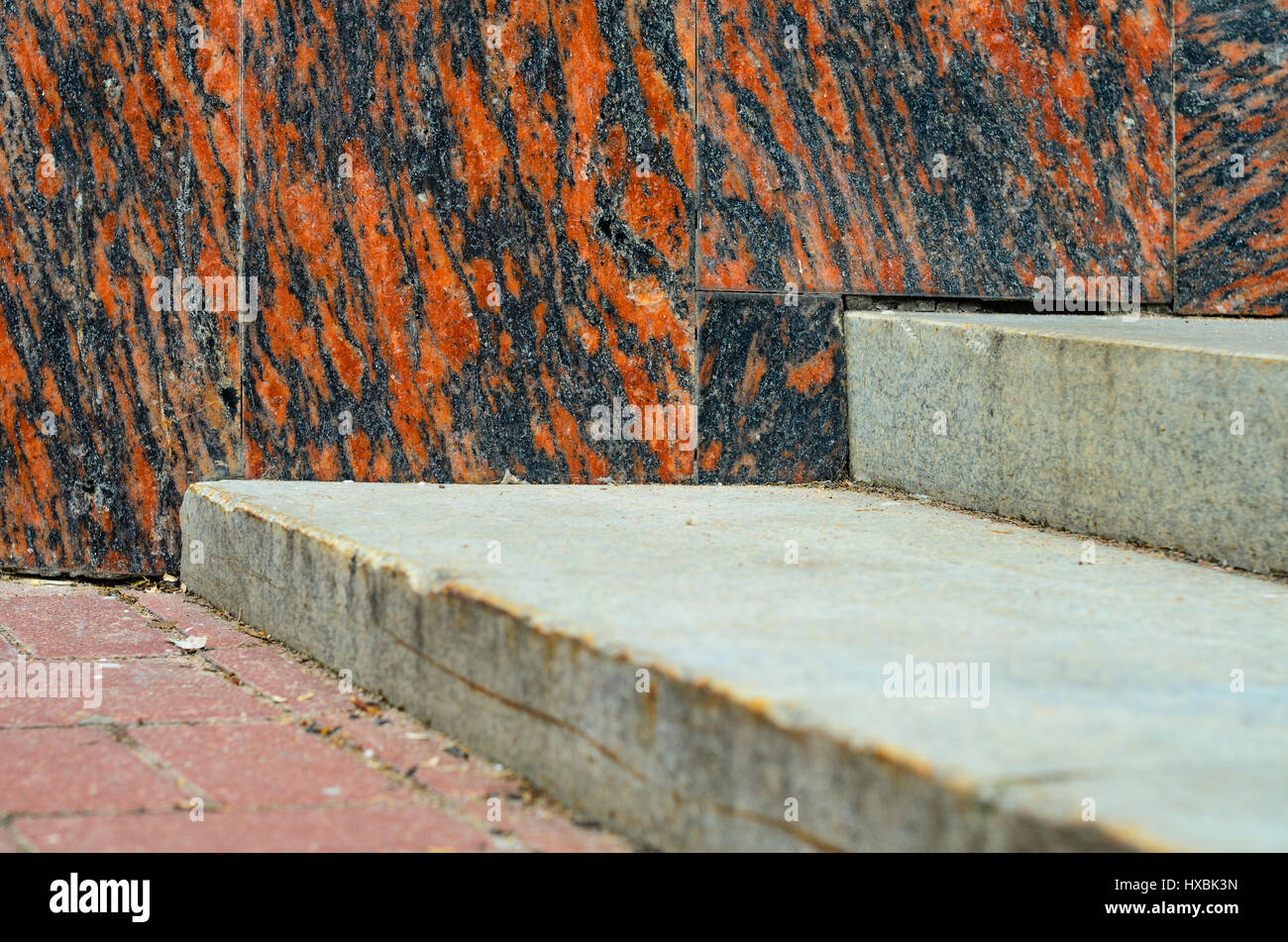 Granite wall texture as background against natural stone stair element ...
