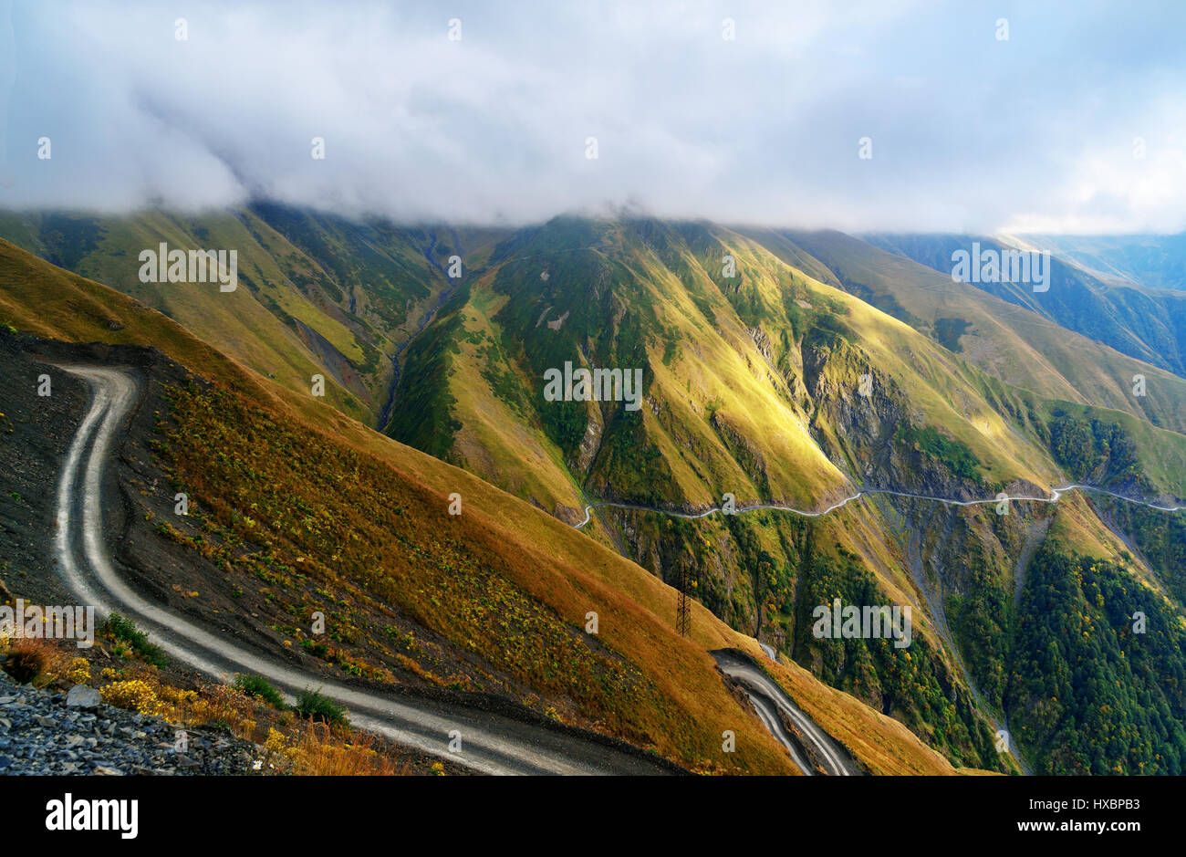 View in the Caucasus Mountains in the clouds. Dangerous road to Omalo ...