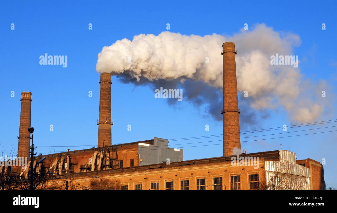 Factory plant smoke stack over blue sky background Stock Photo - Alamy
