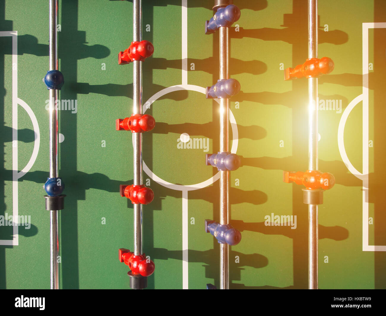 Table football game with red and blue players team in table soccer or ...