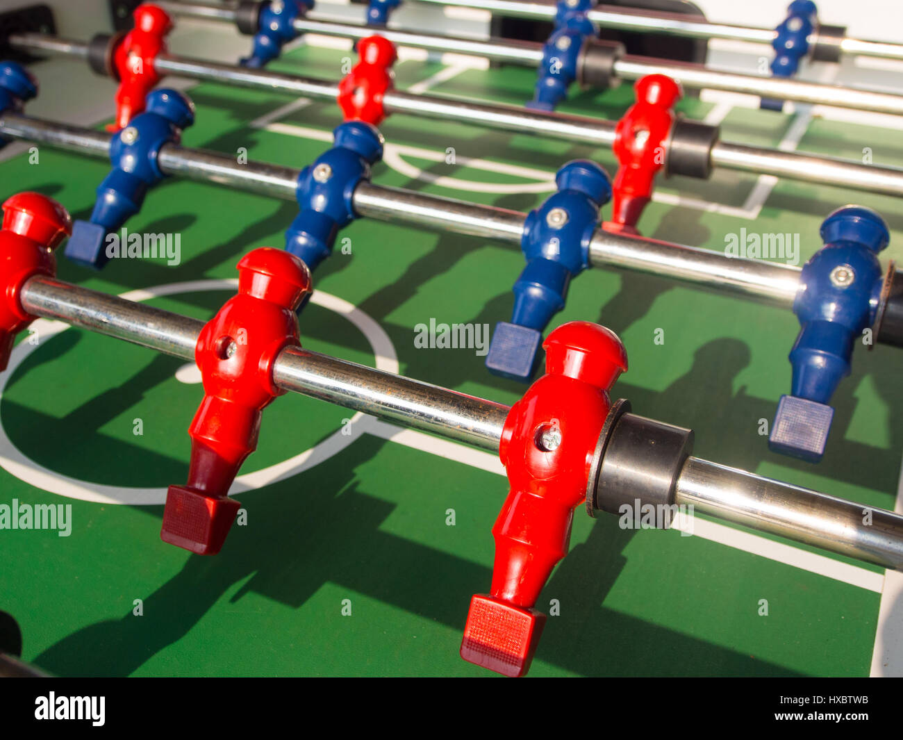 Table football game with red and blue players team in table soccer or ...
