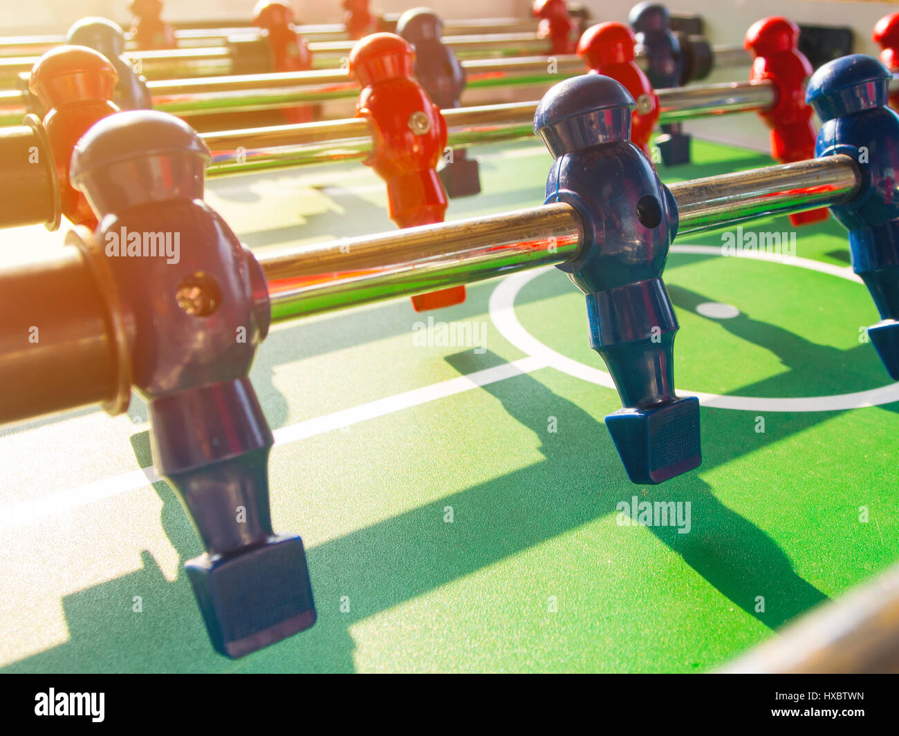 Table football game with red and blue players team in table soccer or ...
