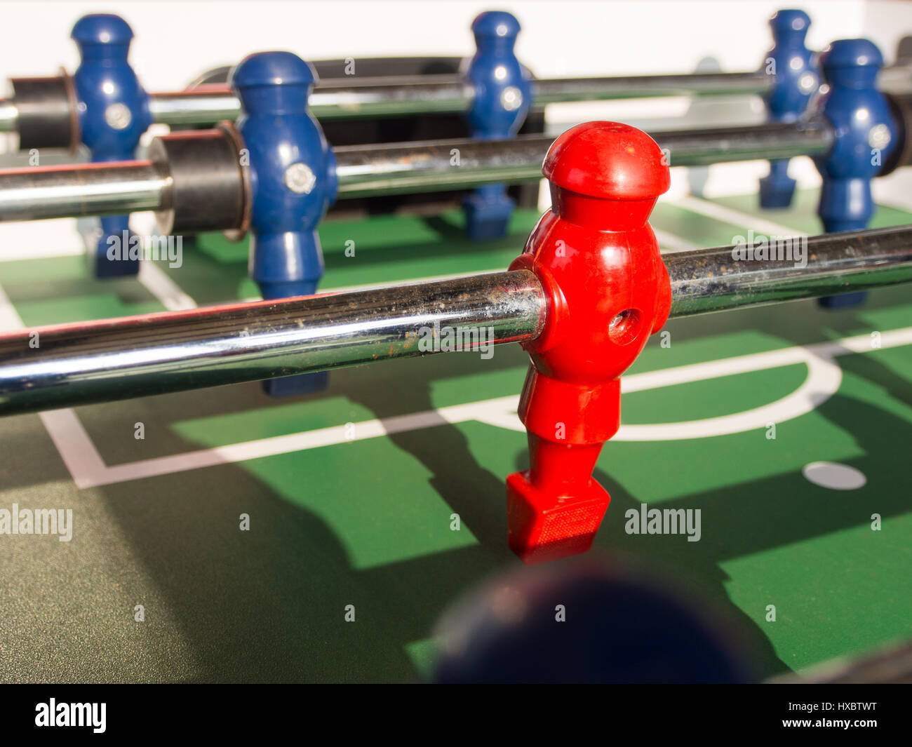 Table football game with red and blue players team in table soccer or ...