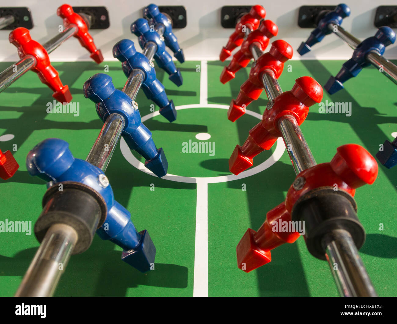 Table football game with red and blue players team in table soccer or ...