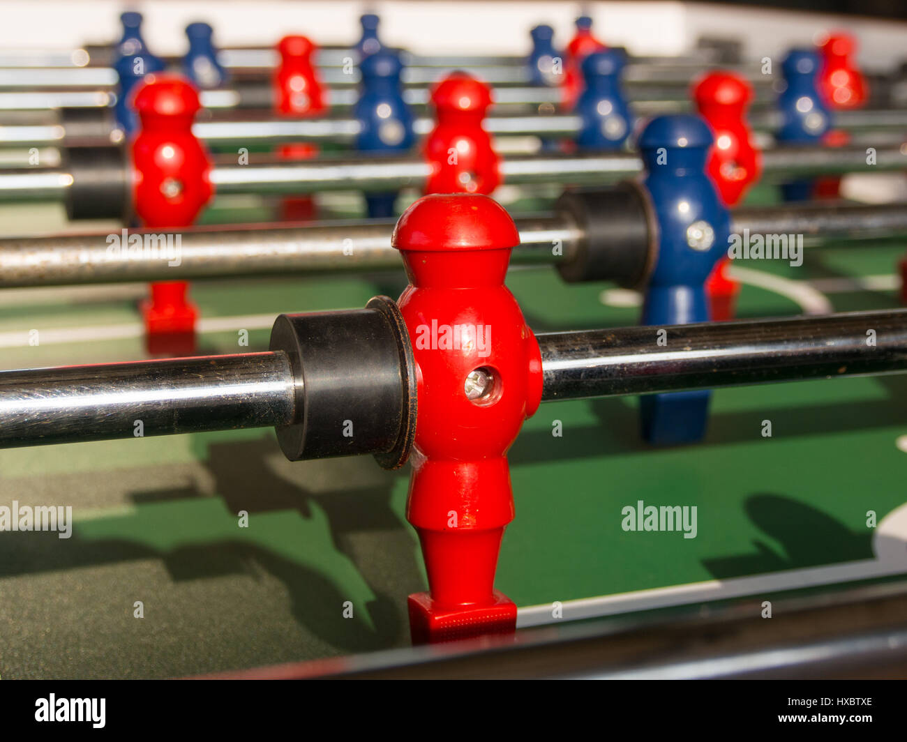 Table football game with red and blue players team in table soccer or ...