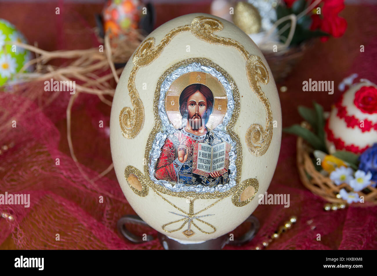 Decorated with textiles and religious motives Easter egg Stock Photo ...