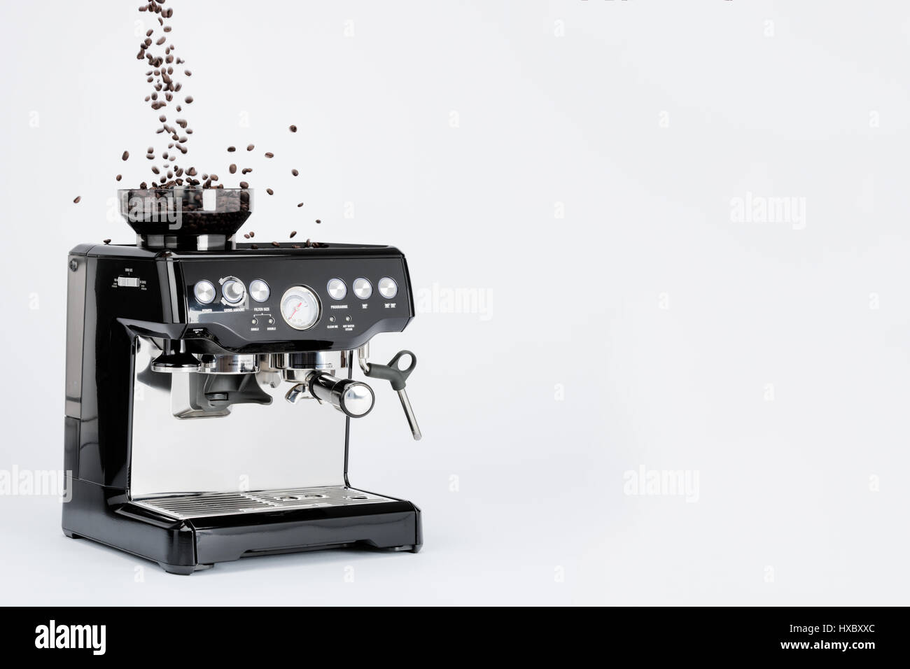 Isolated black manual coffee maker with grinder and falling coffee ...