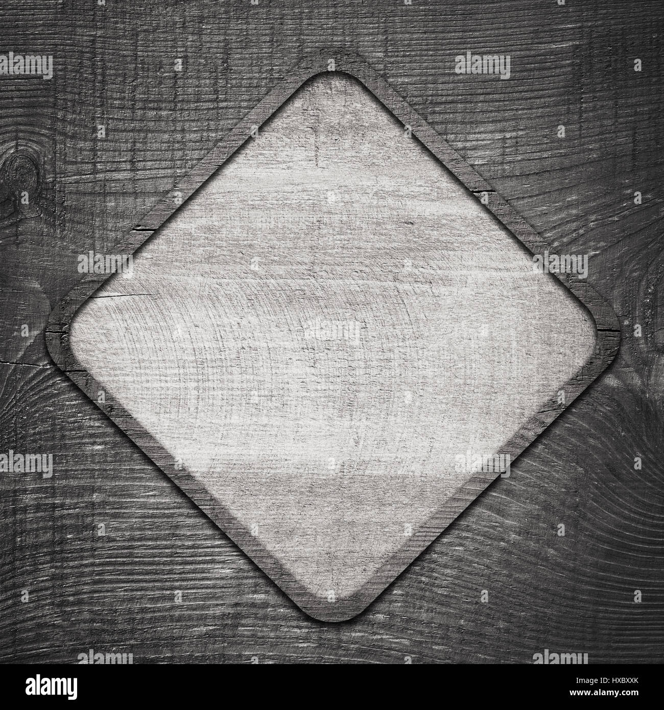 Gray wooden lozenge with frame on dark wall Stock Photo - Alamy