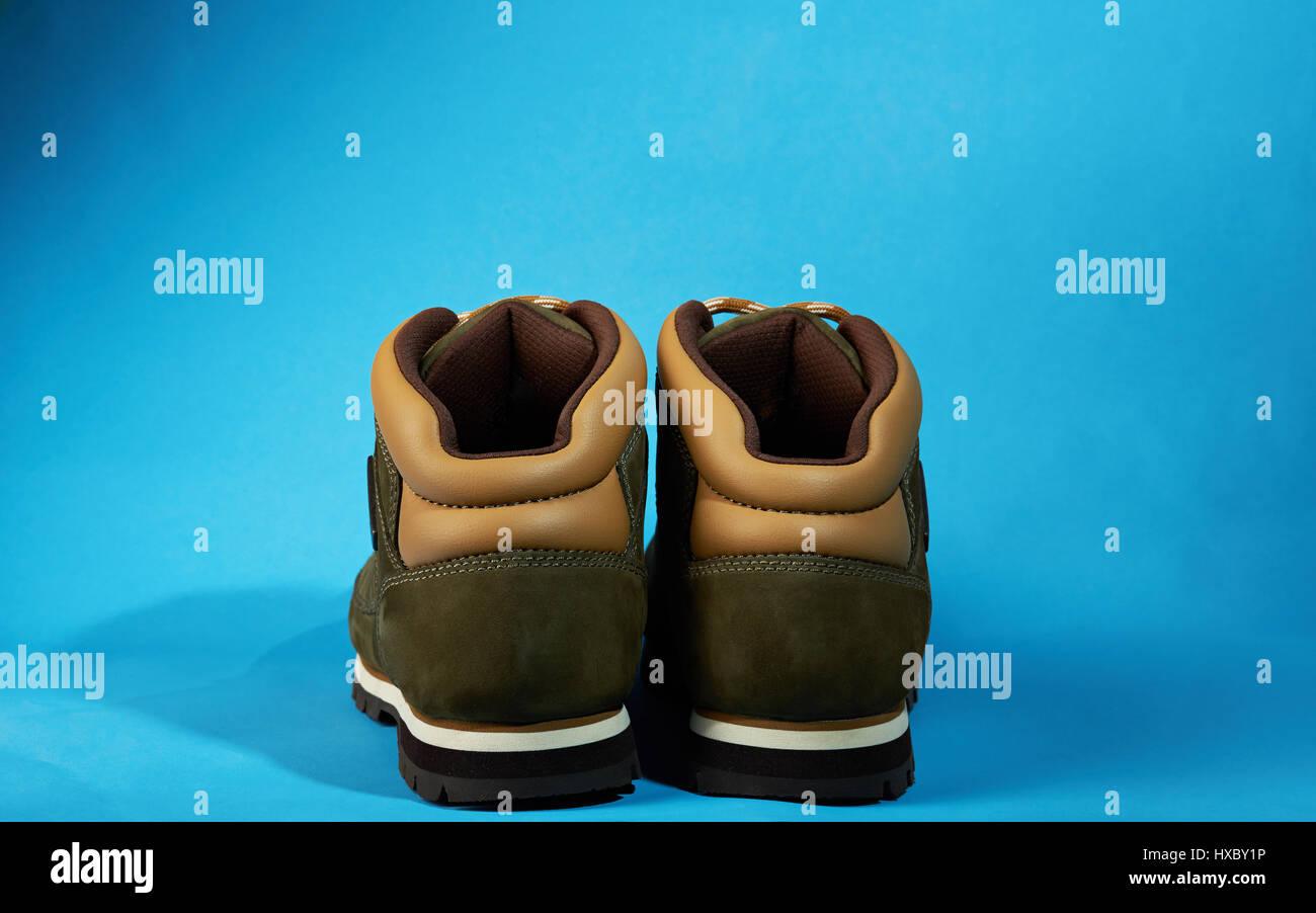 Back view of hiking boots isolated on blue background. New modern hike ...