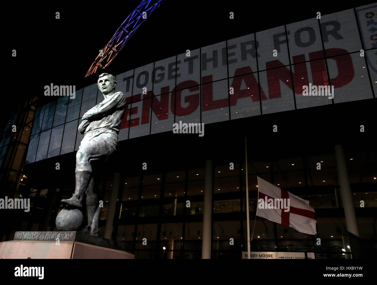 Bobby Moore statue and the England flag at half mast under the Wembley ...