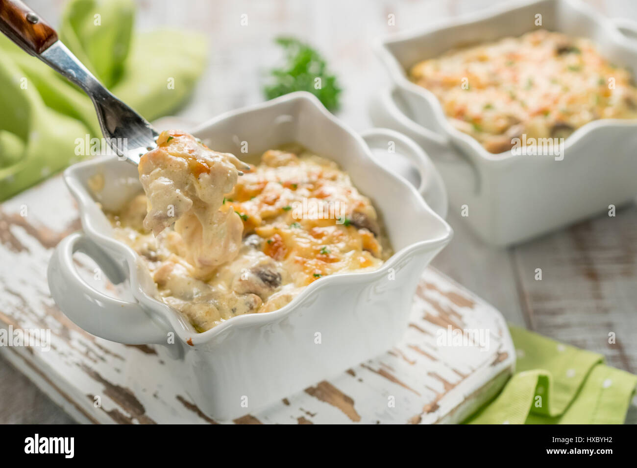 Baked gratin casserole chicken with mushrooms in a cream sauce with ...