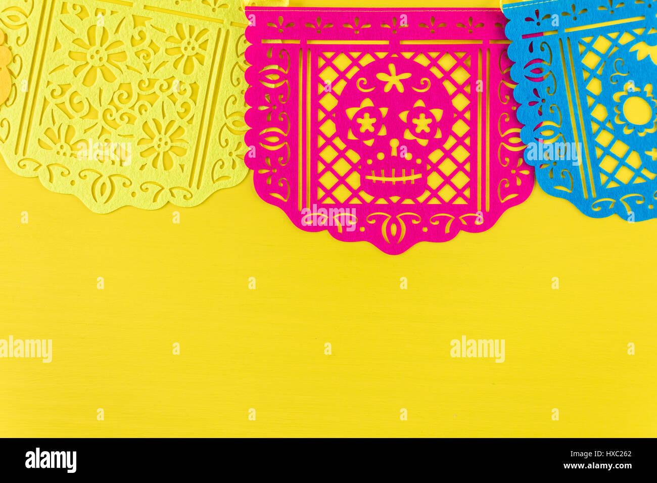 Traditional Mexican papel picado paper banner on a wood background ...
