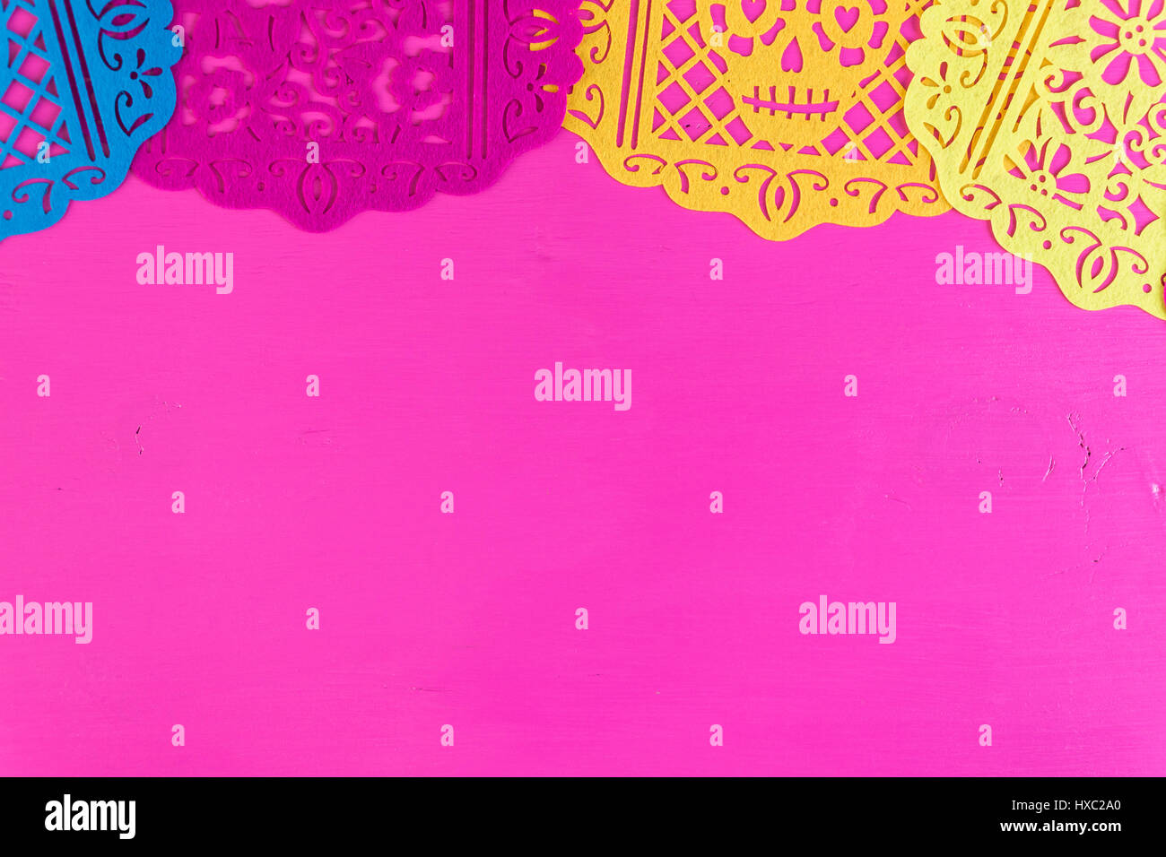 Traditional Mexican papel picado paper banner on a wood background ...