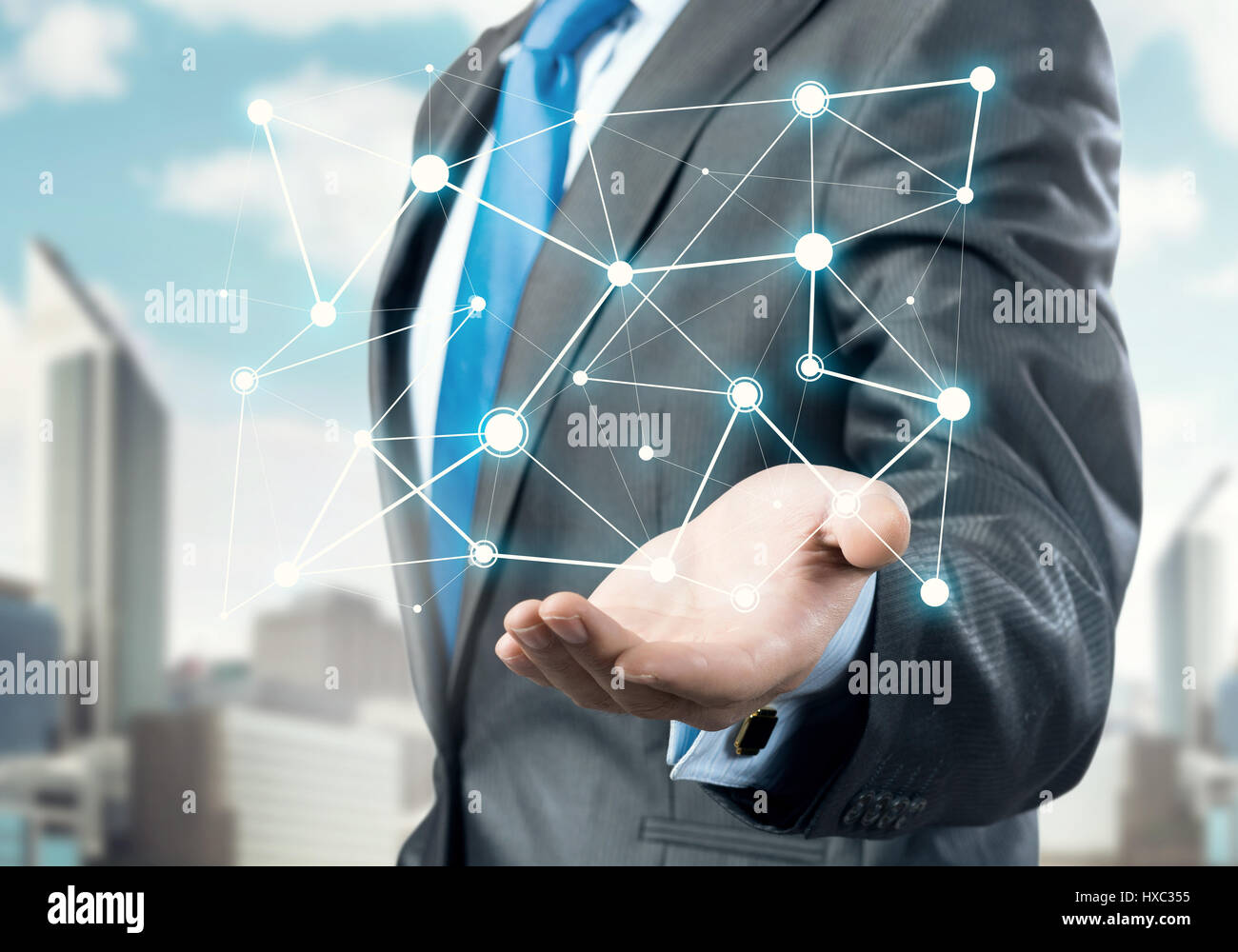 Businessman hand showing digital connection lines on city landscape ...