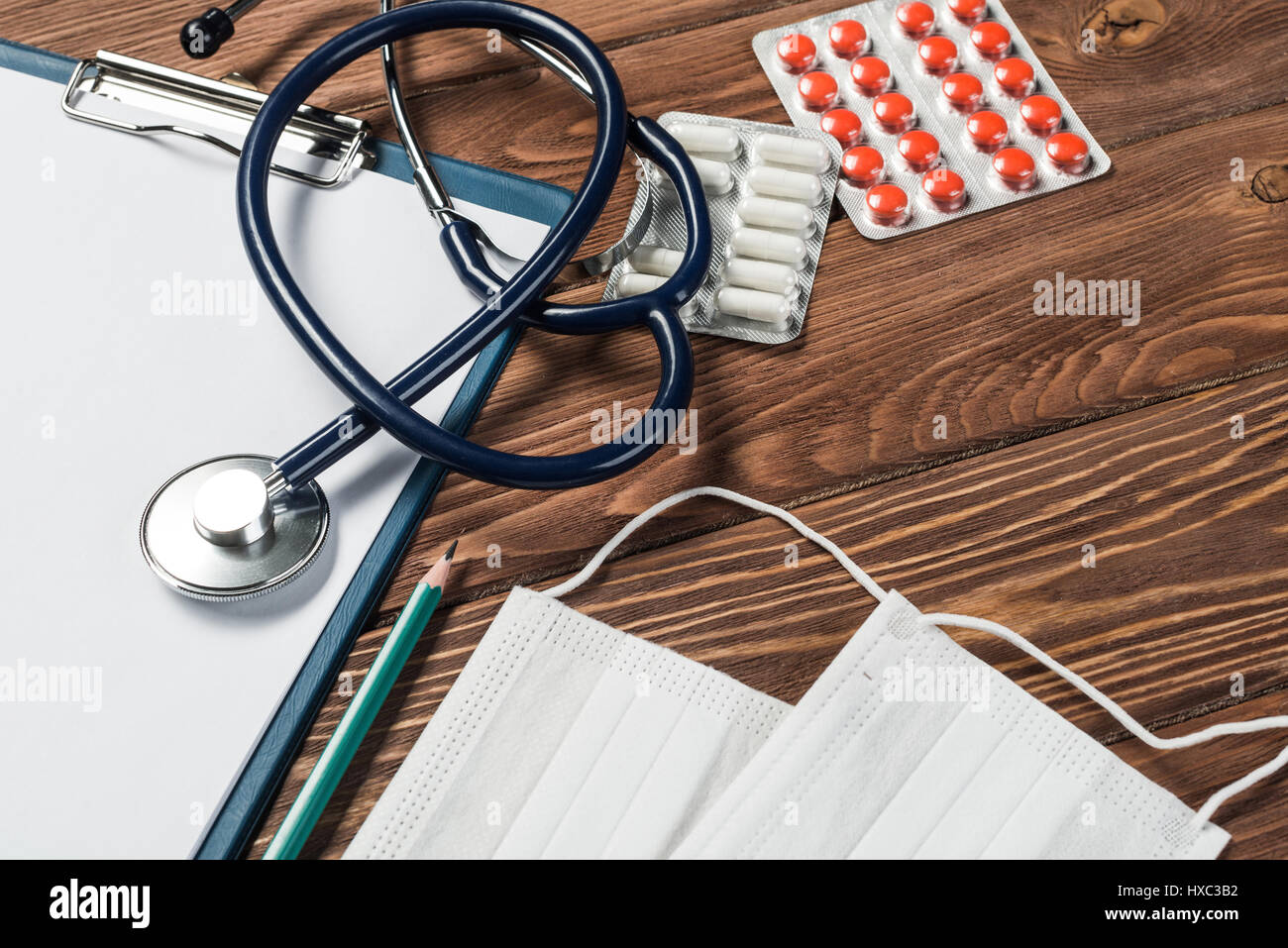 Doctors wooden table with tablet stethoscope and other stuff Stock ...