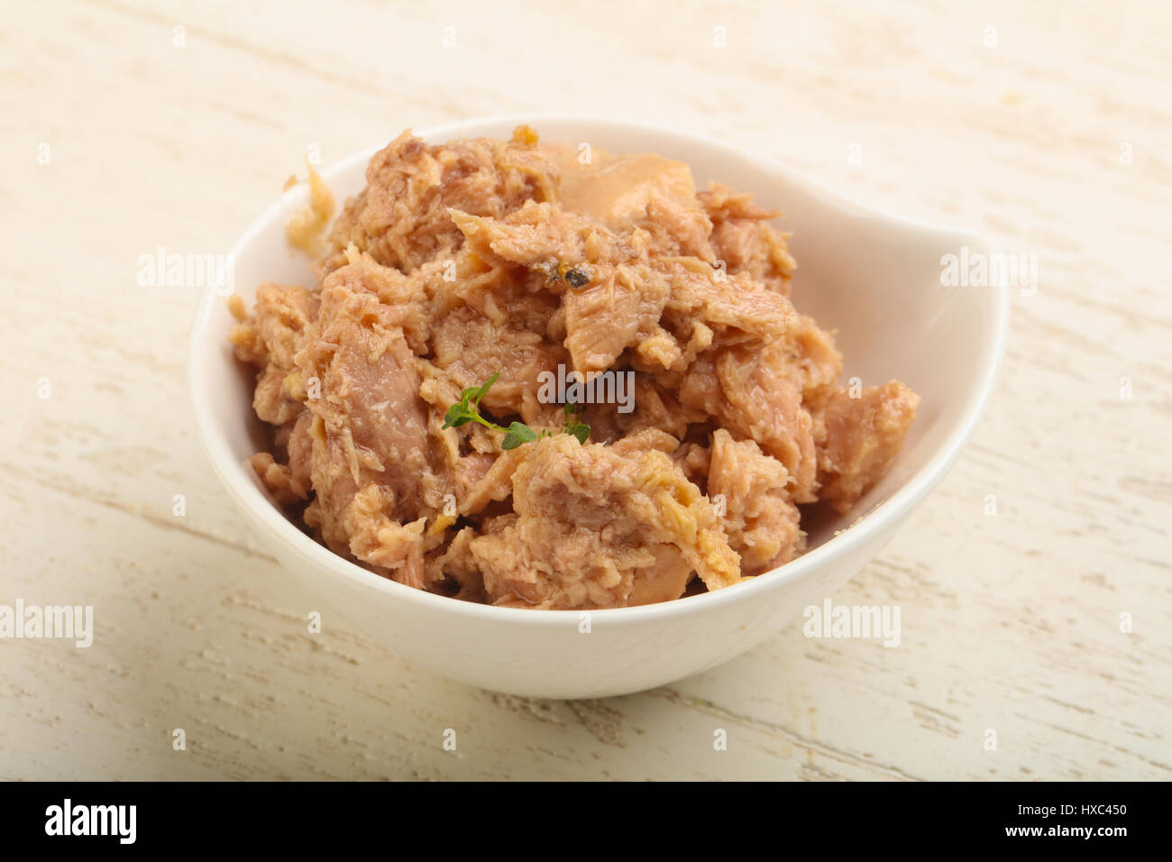 Canned tuna fillet with thyme branch and oil Stock Photo - Alamy