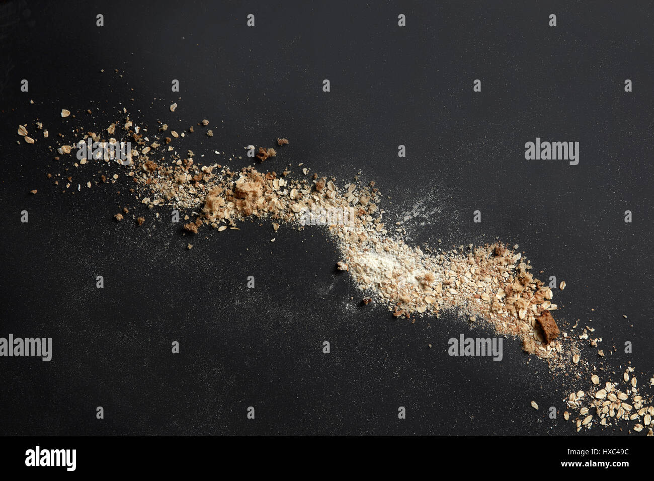 Bread crumbs with flour represented on black background after baking ...