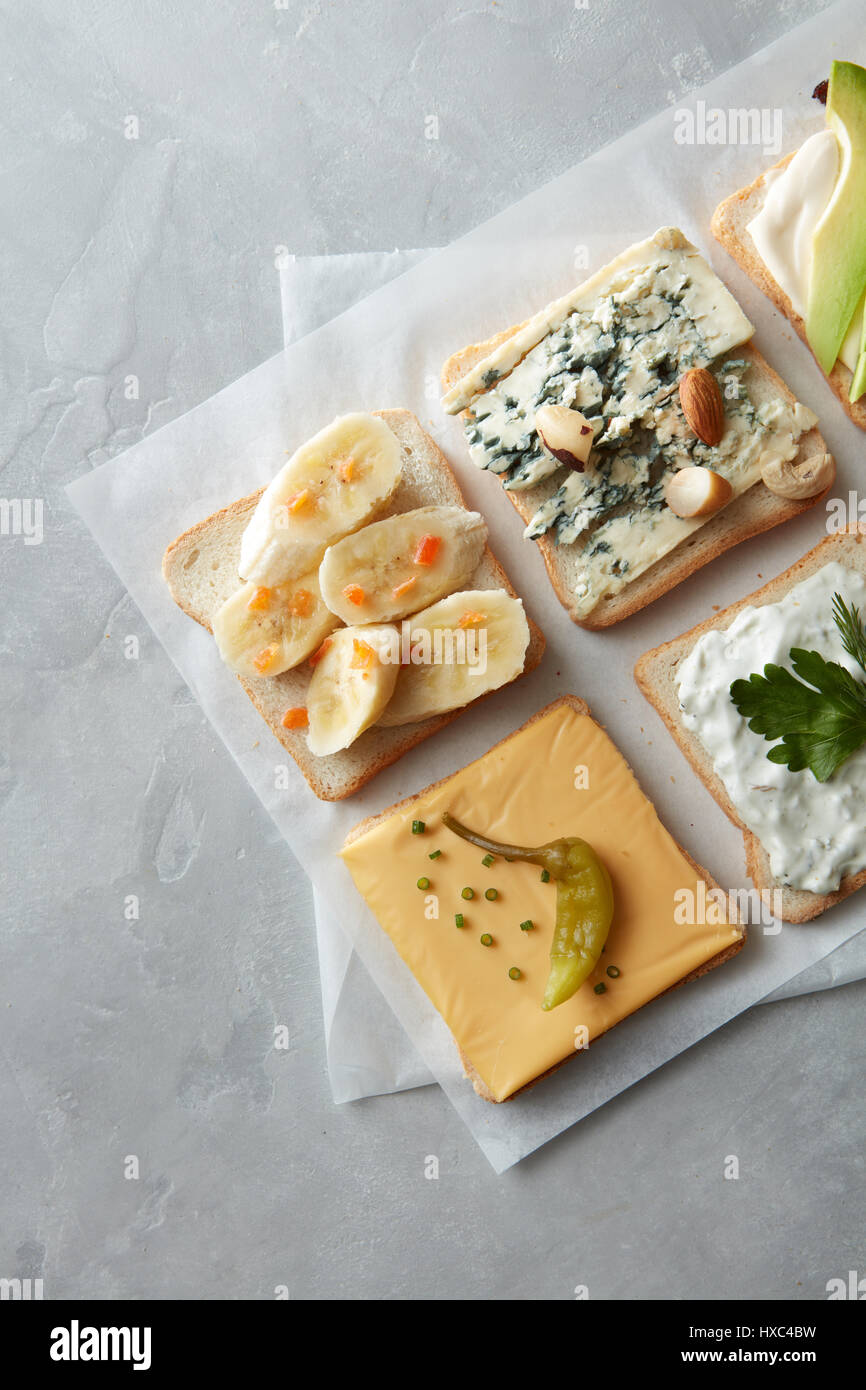 Top view of different kinds of colorful sandwiches on white chalkboard ...