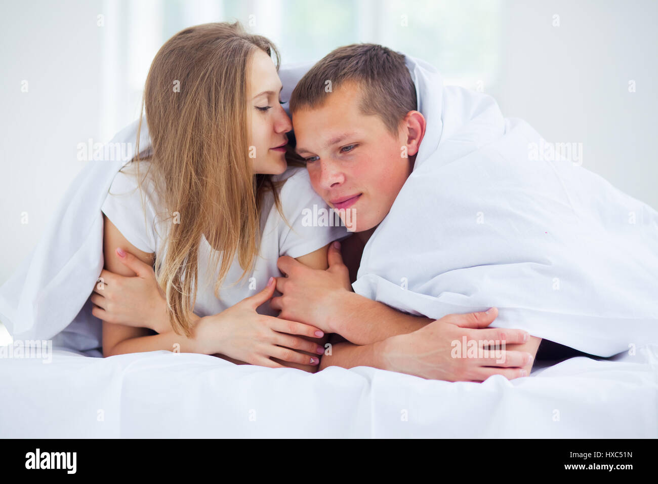 Lifestyle. Beautiful couple in bed Stock Photo - Alamy