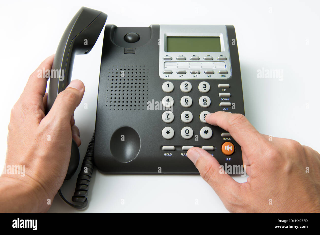 Close up of man dialing on a landline telephone Stock Photo - Alamy
