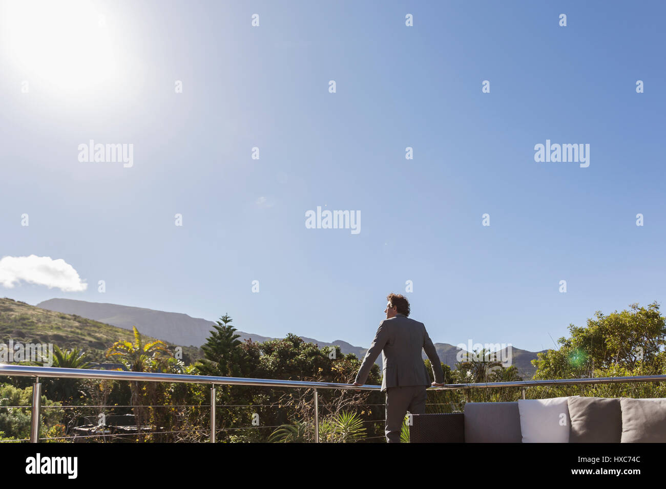 Man leaning on balcony railing hi-res stock photography and images - Alamy