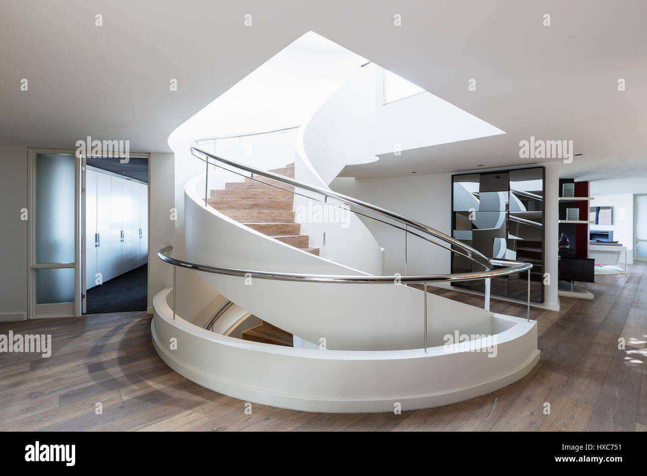 Modern spiral staircase in home showcase interior Stock Photo - Alamy