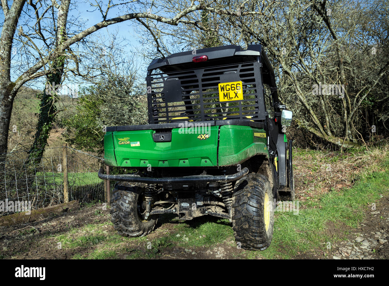 John Deere Gator four wheeler utility vehicle sits in Devon pasture in ...