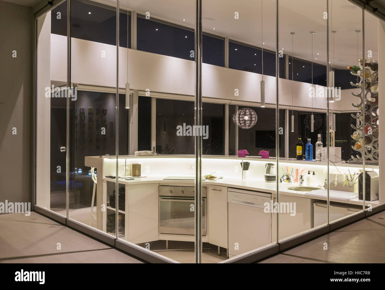 Illuminated modern luxury home showcase interior kitchen at night Stock ...