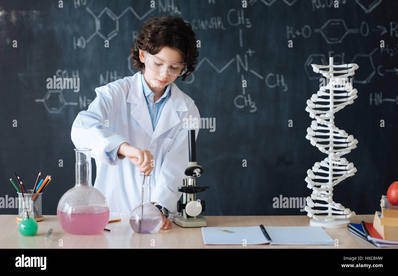 Concentrated little researcher enjoying microbiology class in the ...