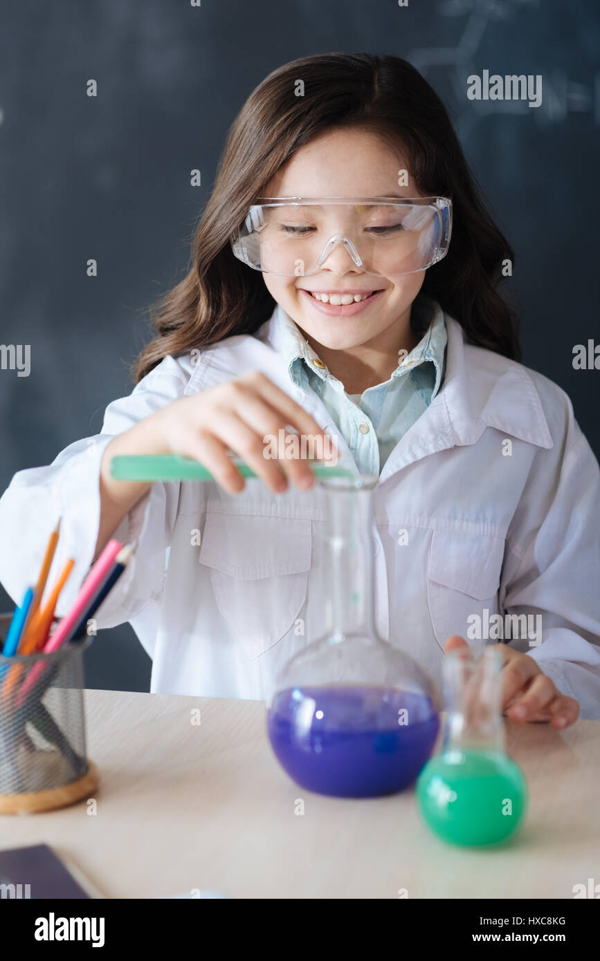 Enjoying my school curriculum. Capable cheerful skilled girl standing ...