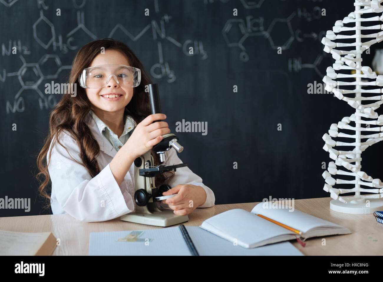 Charming little researcher enjoying medicine experiment at school Stock ...
