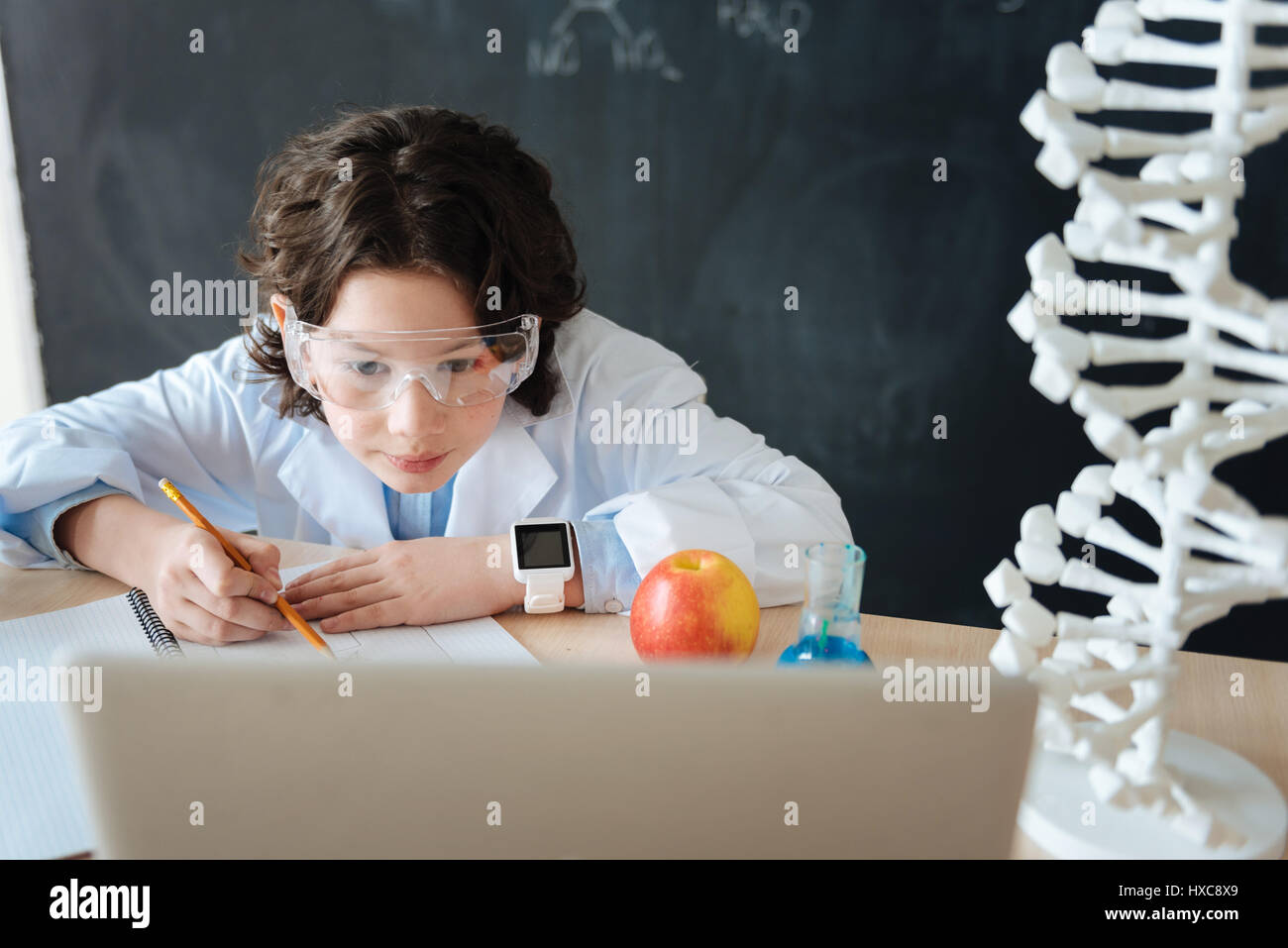 Skilled boy working on the microbiology project in the laboratory Stock ...