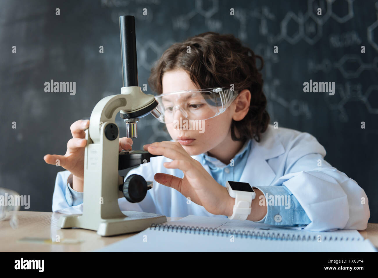 Charming little scientist studying biotechnology at school Stock Photo ...