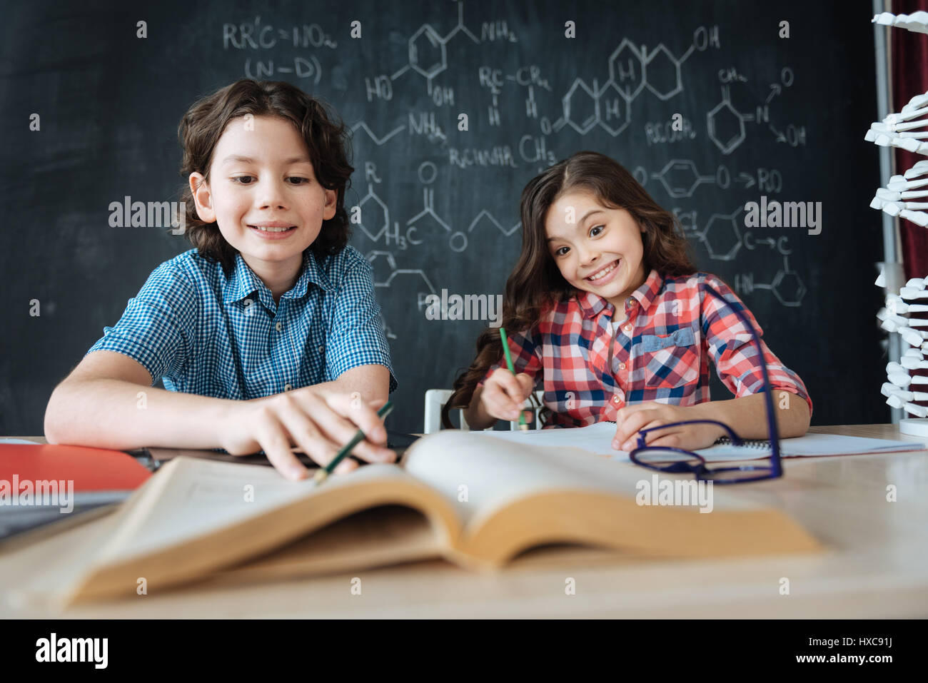 Joyful friends taking notes at school Stock Photo - Alamy