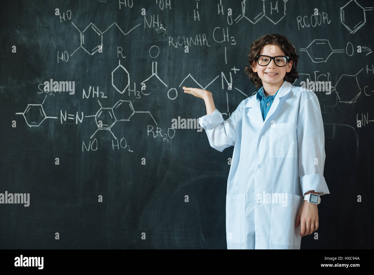 The best pupil in the class. Skilled shy delighted pupil standing near ...