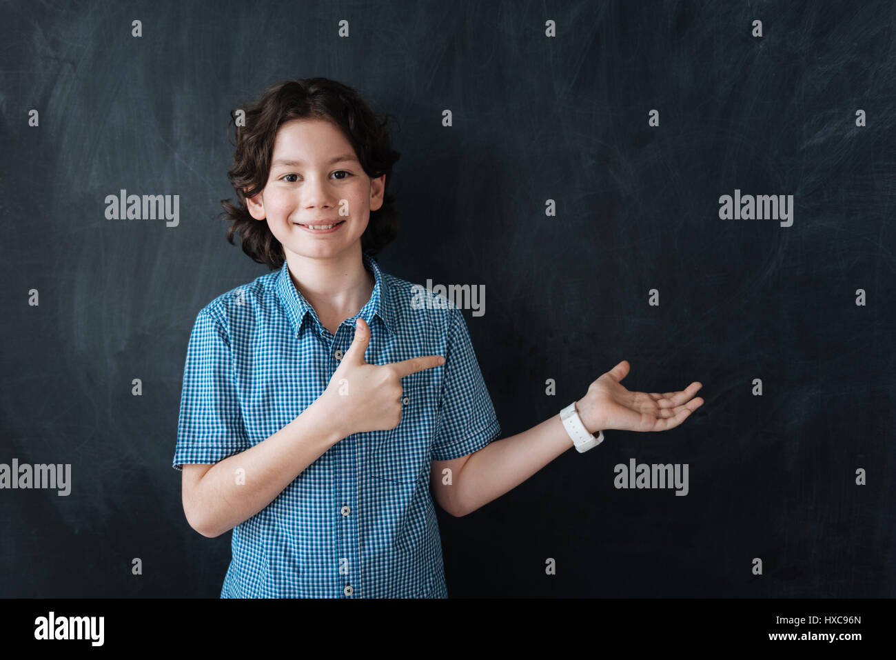 Charming little boy offering a choice in the studio Stock Photo - Alamy